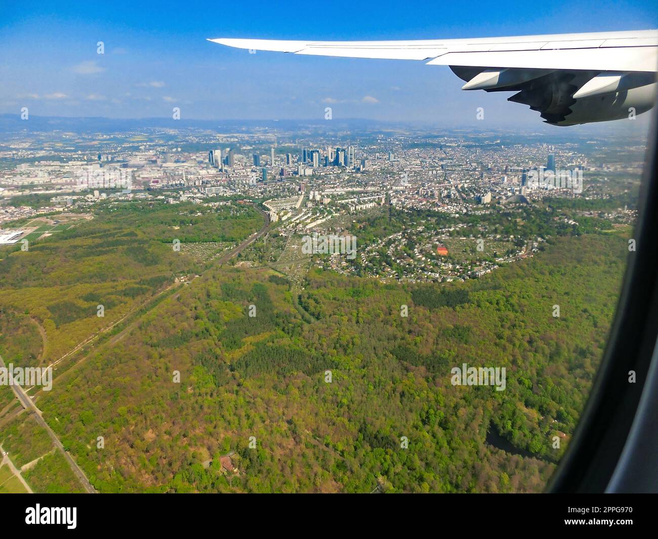 Airplane window view of wing, highway junctions and green forest Stock ...