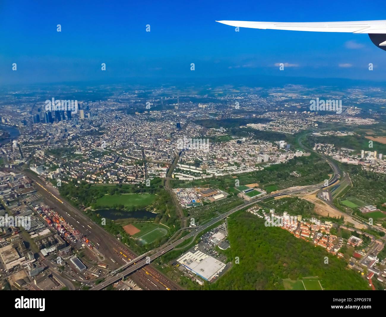 Airplane window view of wing, highway junctions and green forest Stock ...