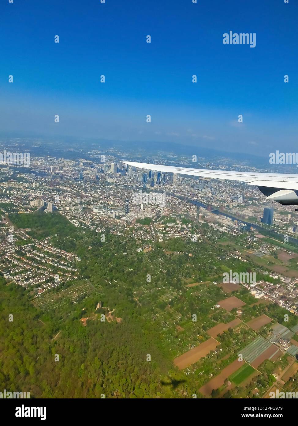 Airplane window view of wing, highway junctions and green forest Stock ...