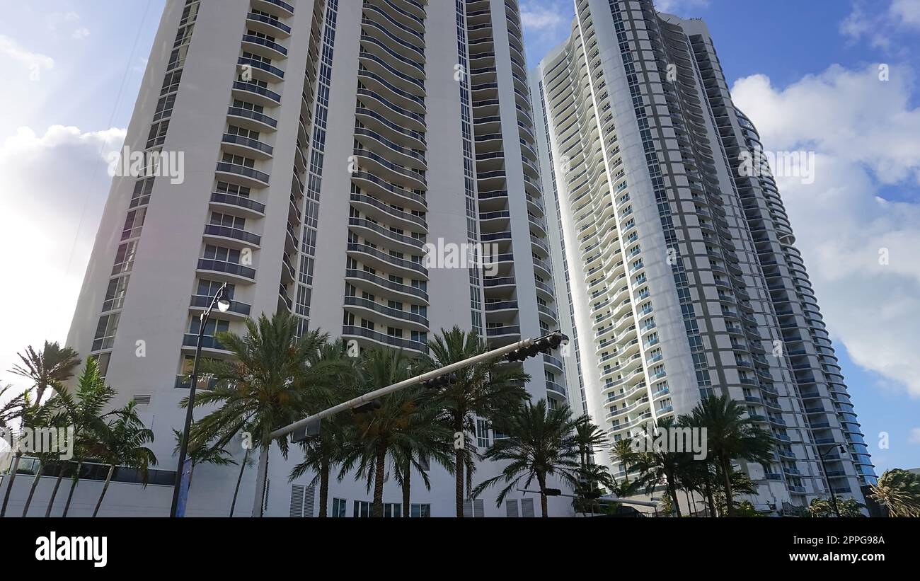 Modern apartment buildings with palm trees at Miami - view from road ...