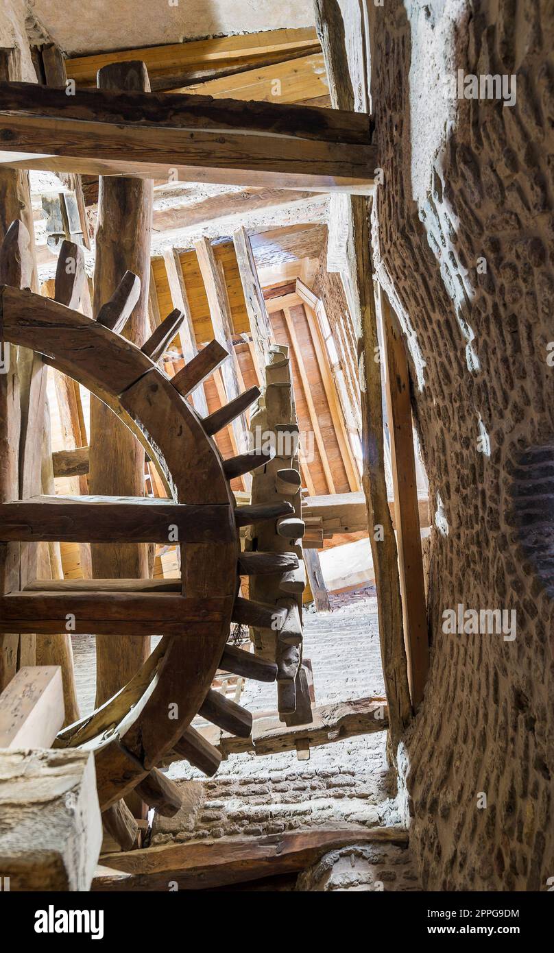 From below shot of aged water mill turning inside weathered mill ...