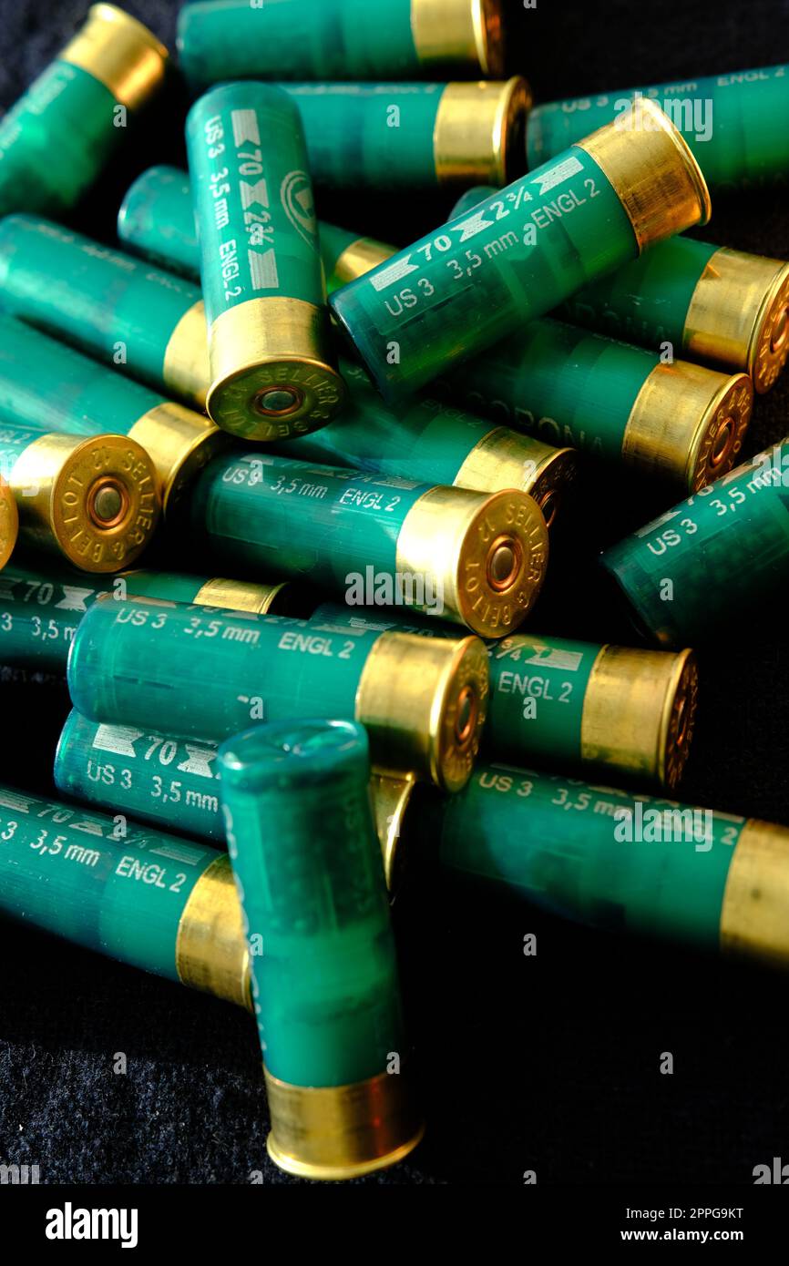 Shotgun shells on a black surface. Ammunition for 12 gauge smoothbore ...