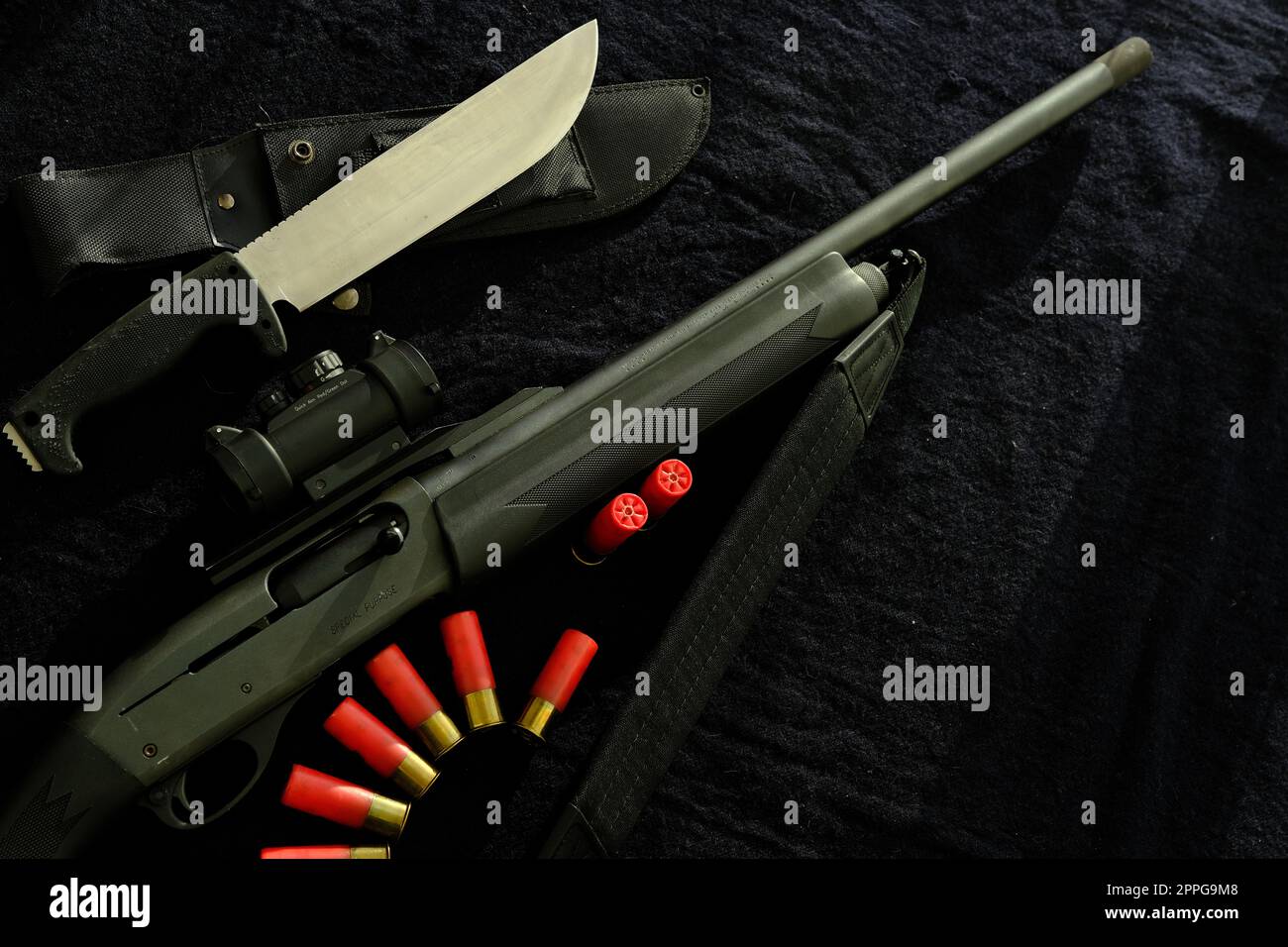 Weapon on black cloth: knife, rifle, shells,top view. Top view of knife ...