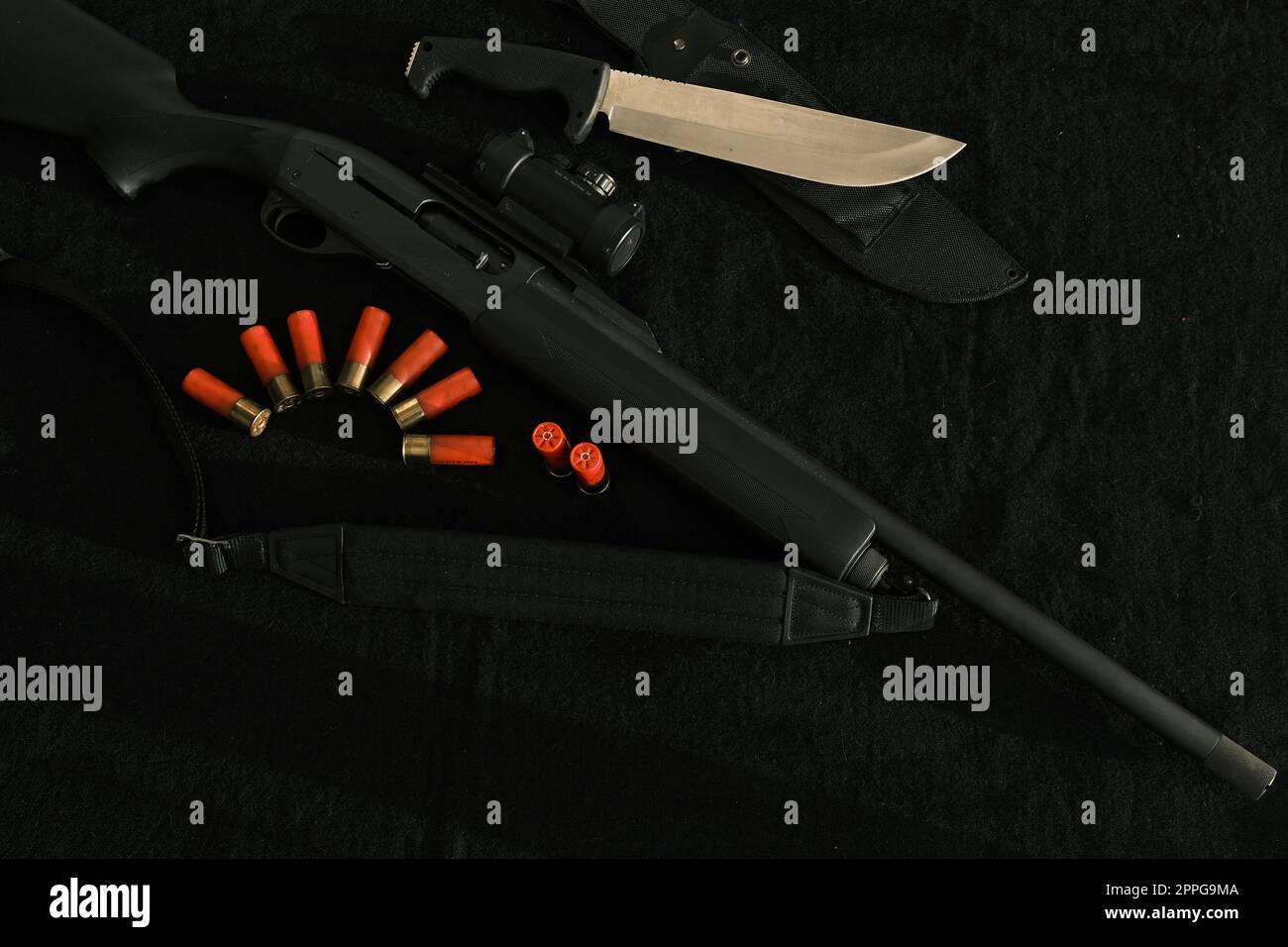 Weapon on black cloth: knife, rifle, shells,top view. Top view of knife ...