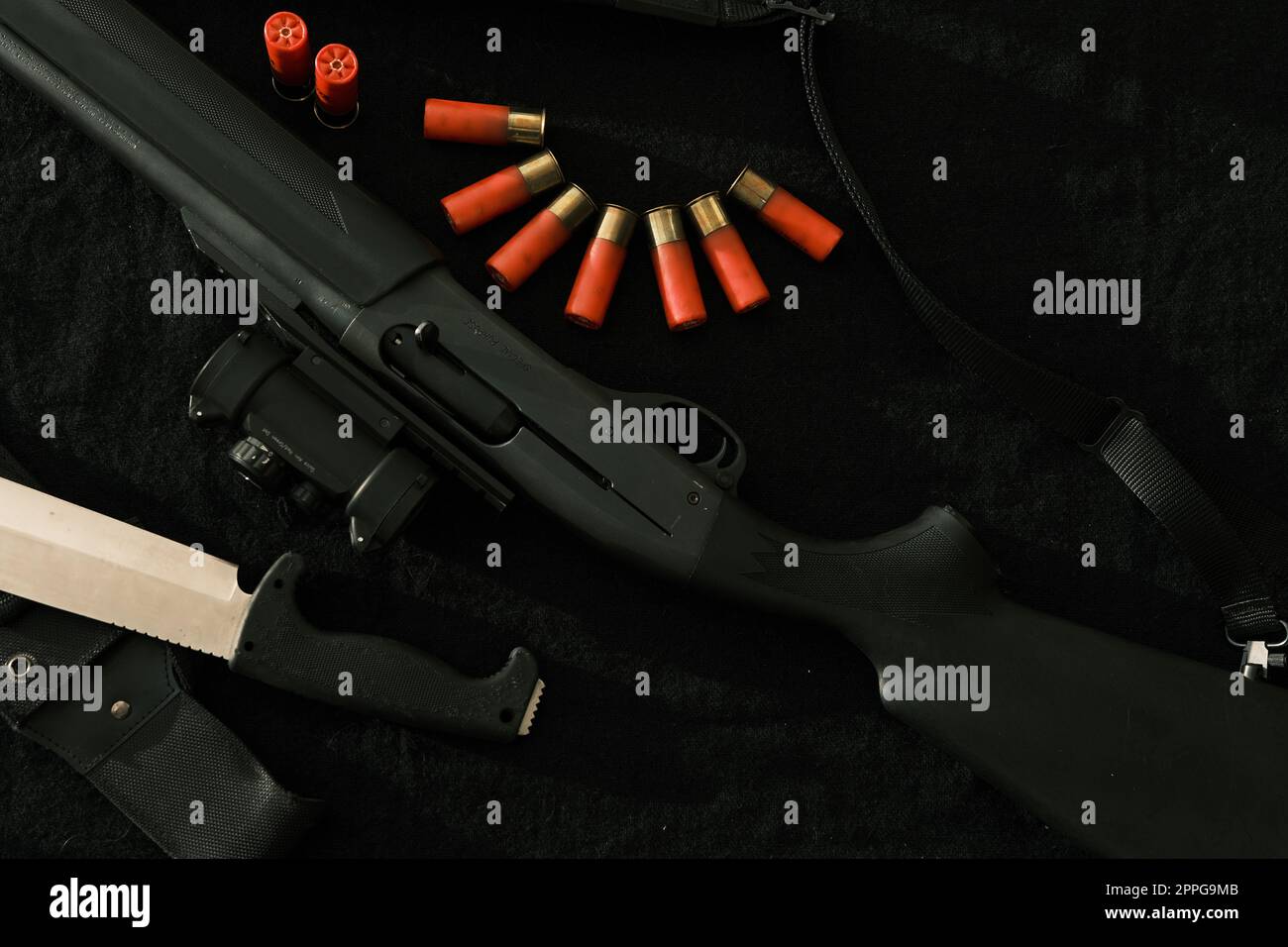 Weapon on black cloth: knife, rifle, shells,top view. Top view of knife ...