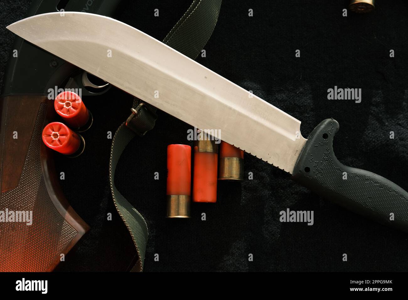 Weapon on black cloth: knife, rifle, shells,top view. Top view of knife ...