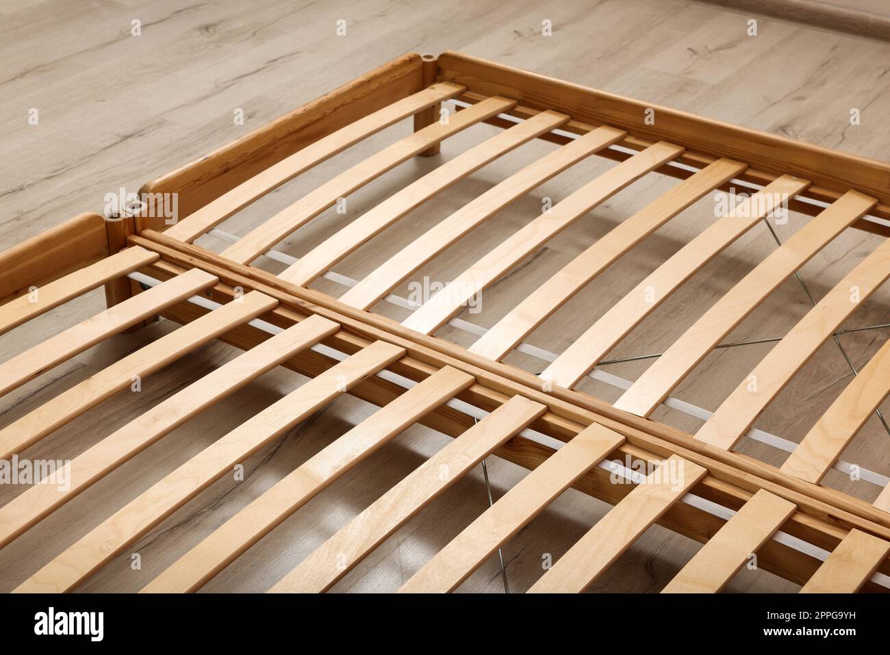 Wooden bed frame on floor, closeup view Stock Photo - Alamy