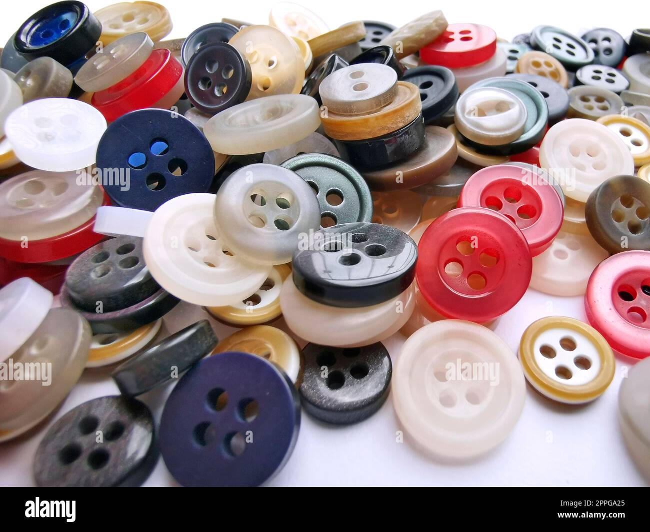 clothing buttons on white background Stock Photo - Alamy