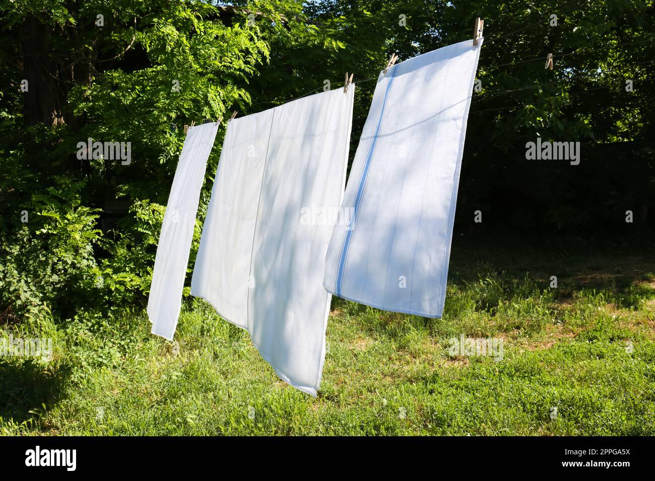 Washing line with clean laundry and clothespins outdoors Stock Photo ...