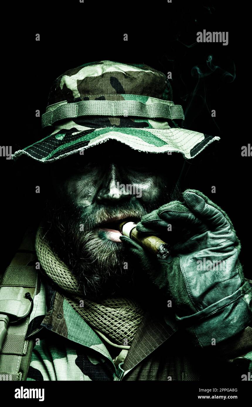 Commando soldier in boonie hat smoking cigar Stock Photo - Alamy