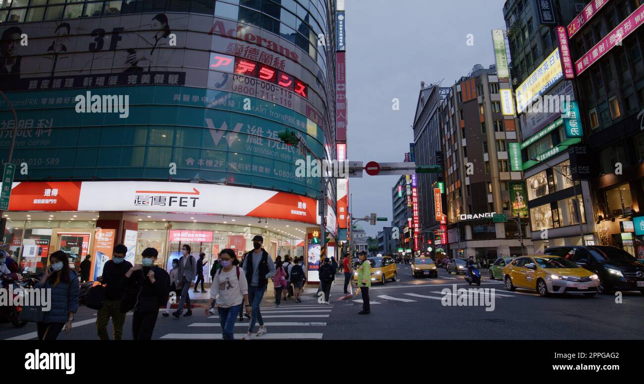 Taipei, Taiwan, 20 March 2022: Taipei city street with people cross the ...