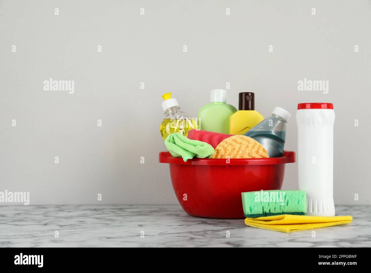 Red basin with cleaning products on marble table. Space for text Stock ...