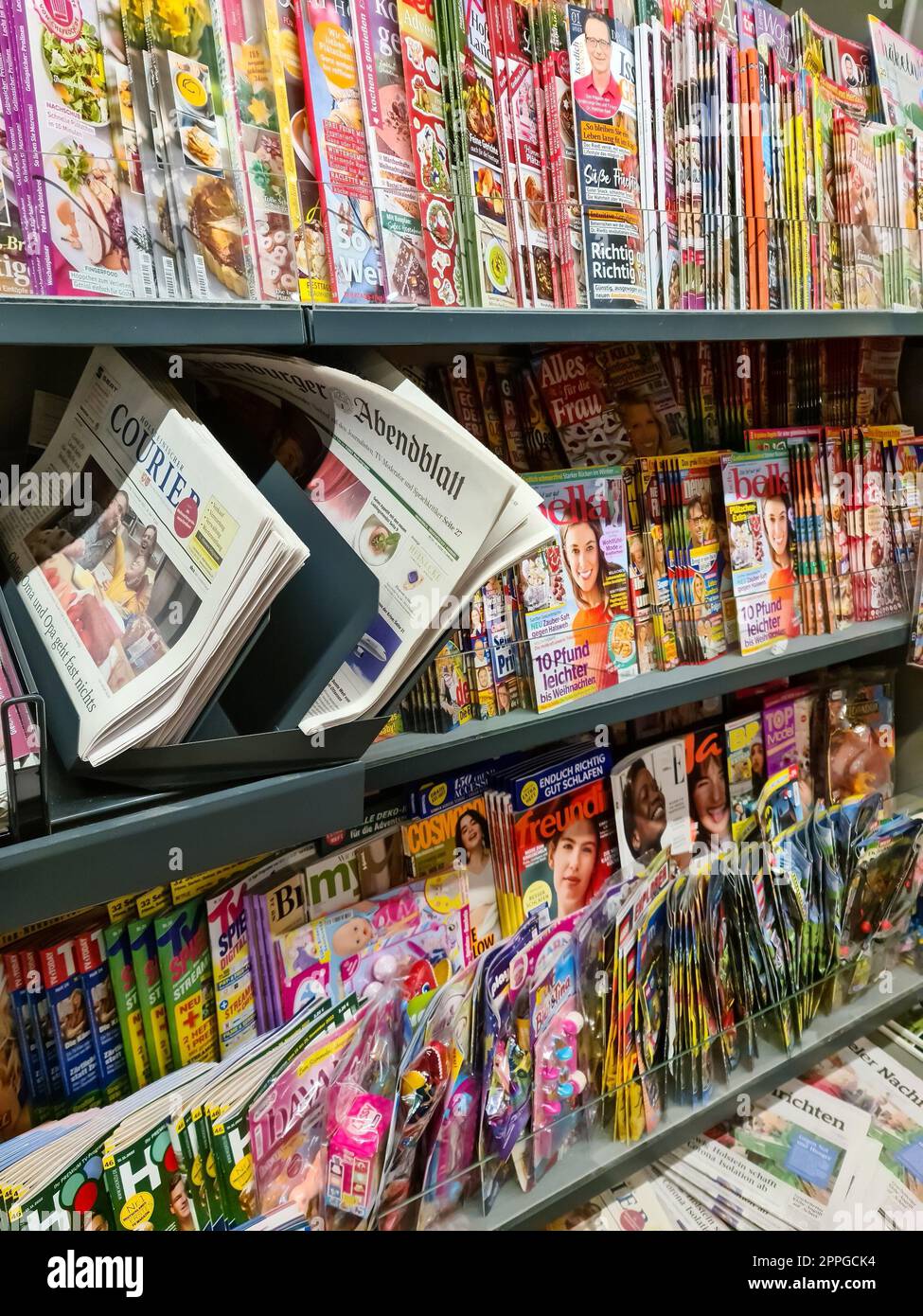 Kiel, Germany - 25.November 2022: A shelf with German newspapers and magazines in a supermarket ...