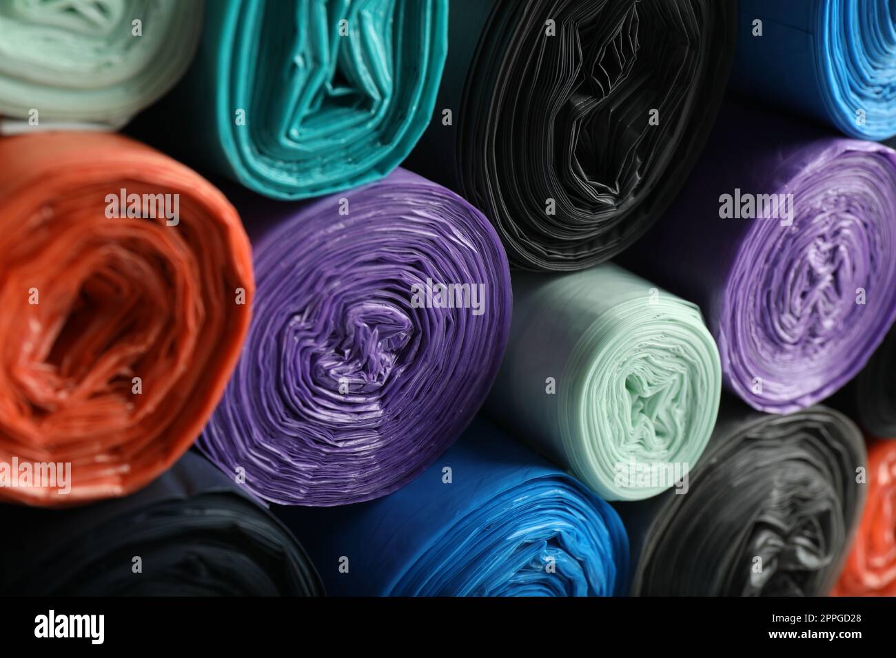 Rolls of different color garbage bags as background, closeup Stock ...