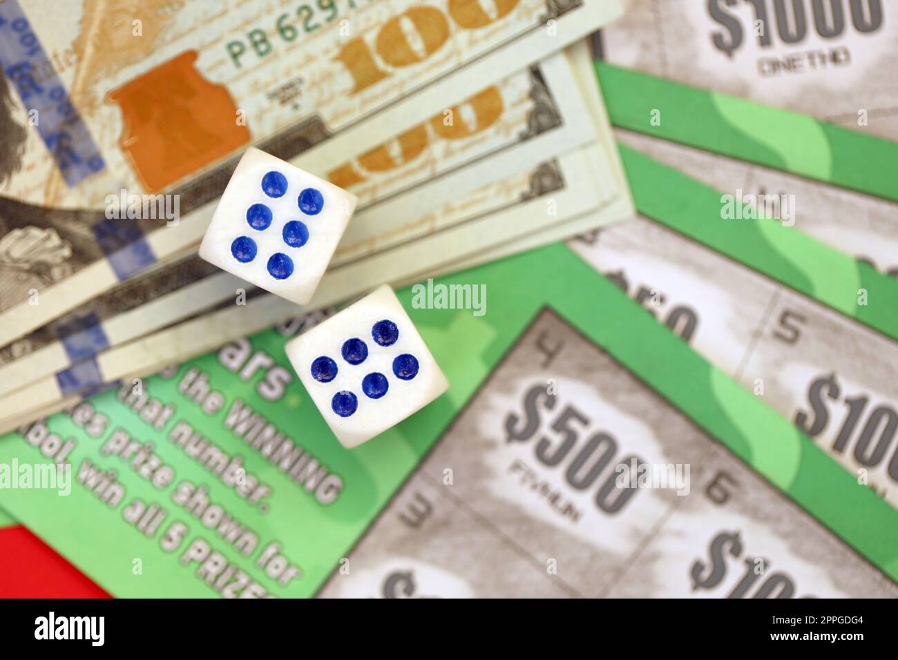 Close up view of green lottery scratch cards with us dollar bills and ...