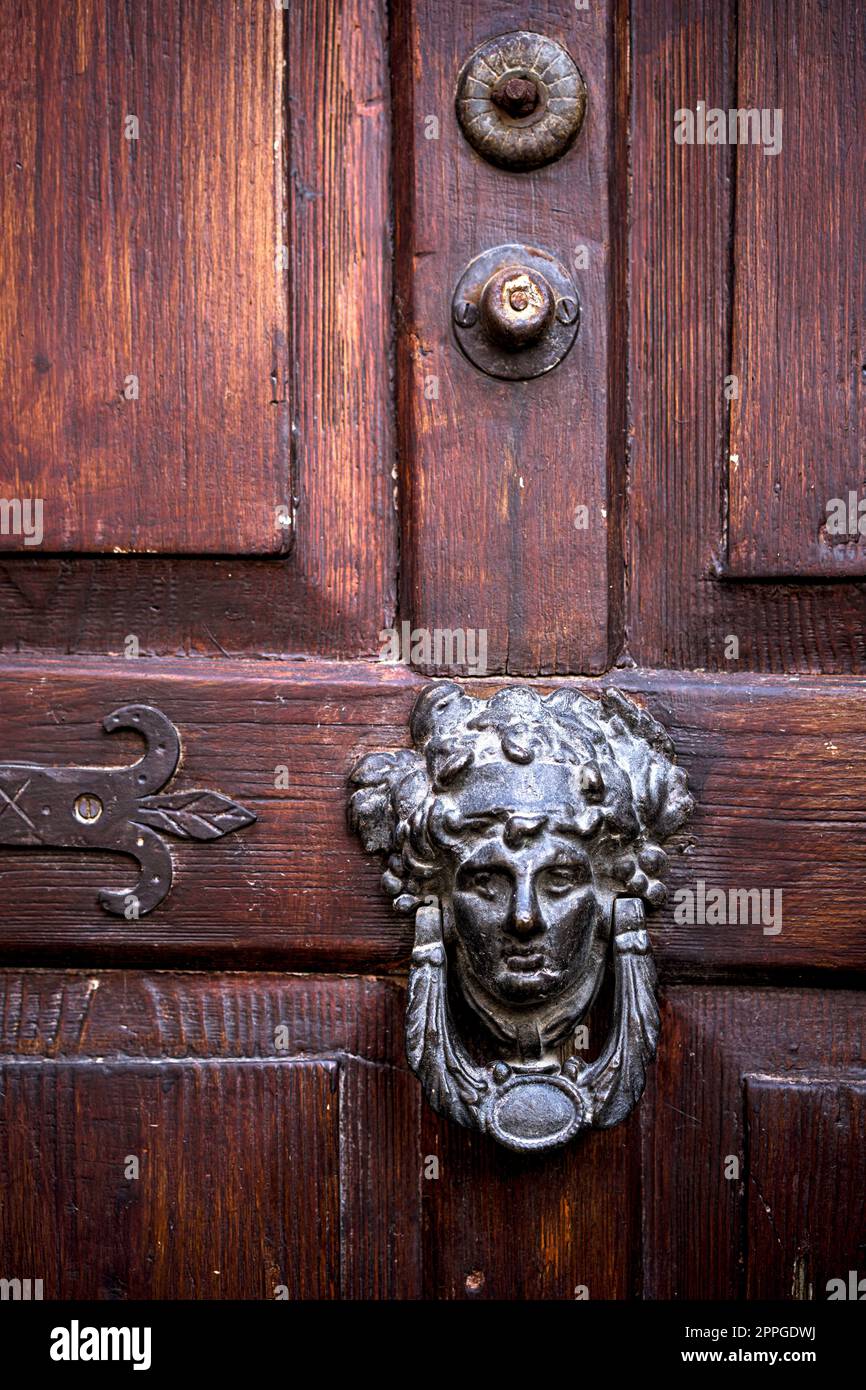 Metal door knocker with a human face Stock Photo - Alamy
