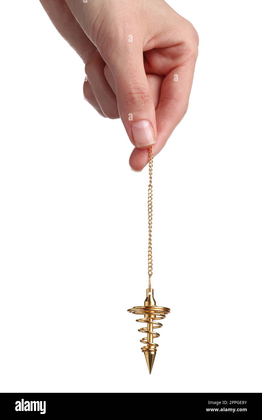 Woman holding golden pendulum with chain on white background, closeup ...