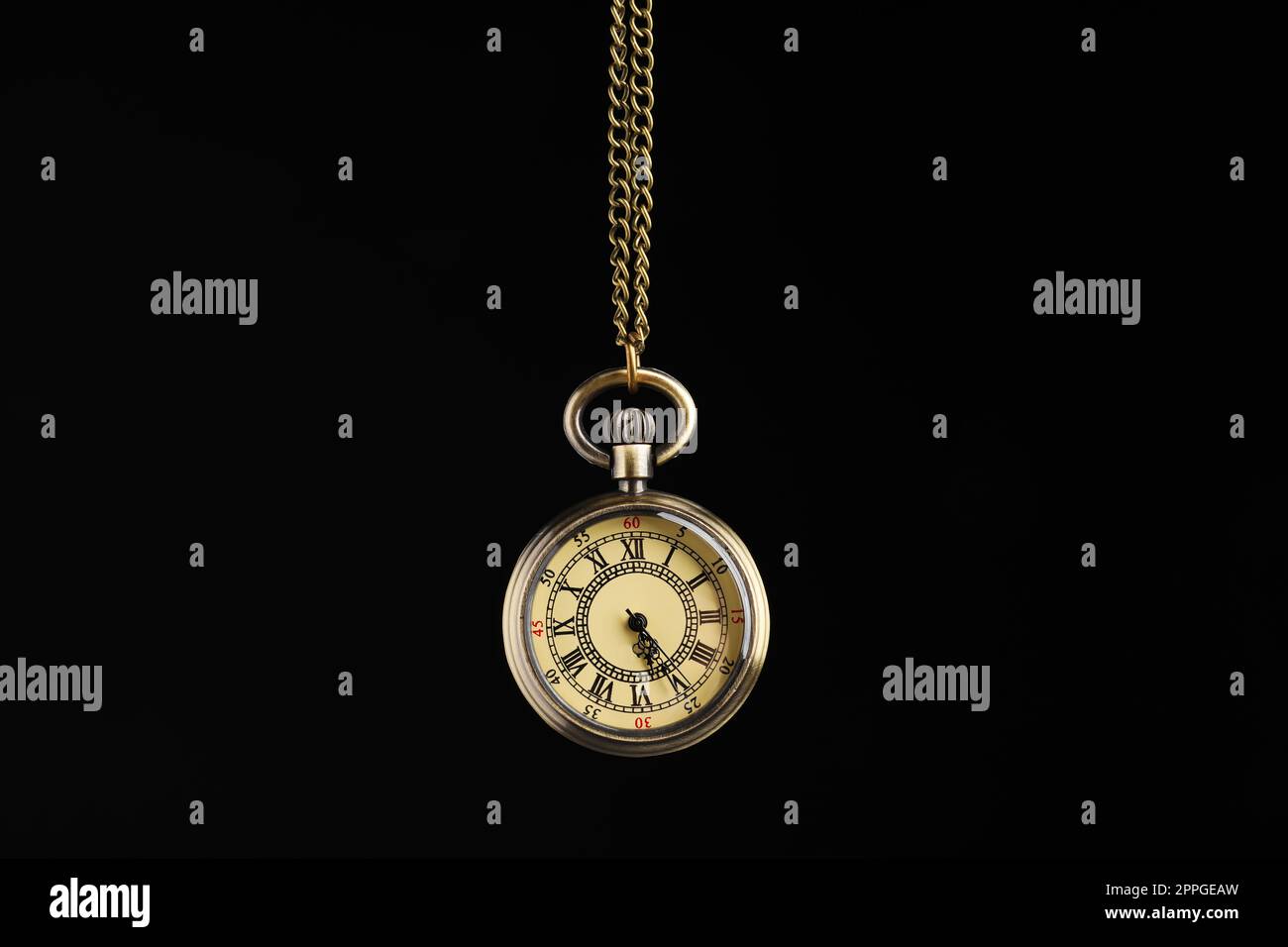 Beautiful vintage pocket watch with chain on black background. Hypnosis ...