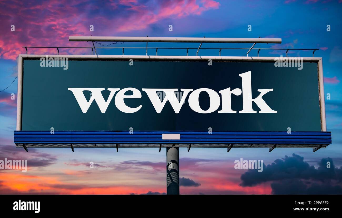 Advertisement billboard displaying logo of WeWork Stock Photo - Alamy