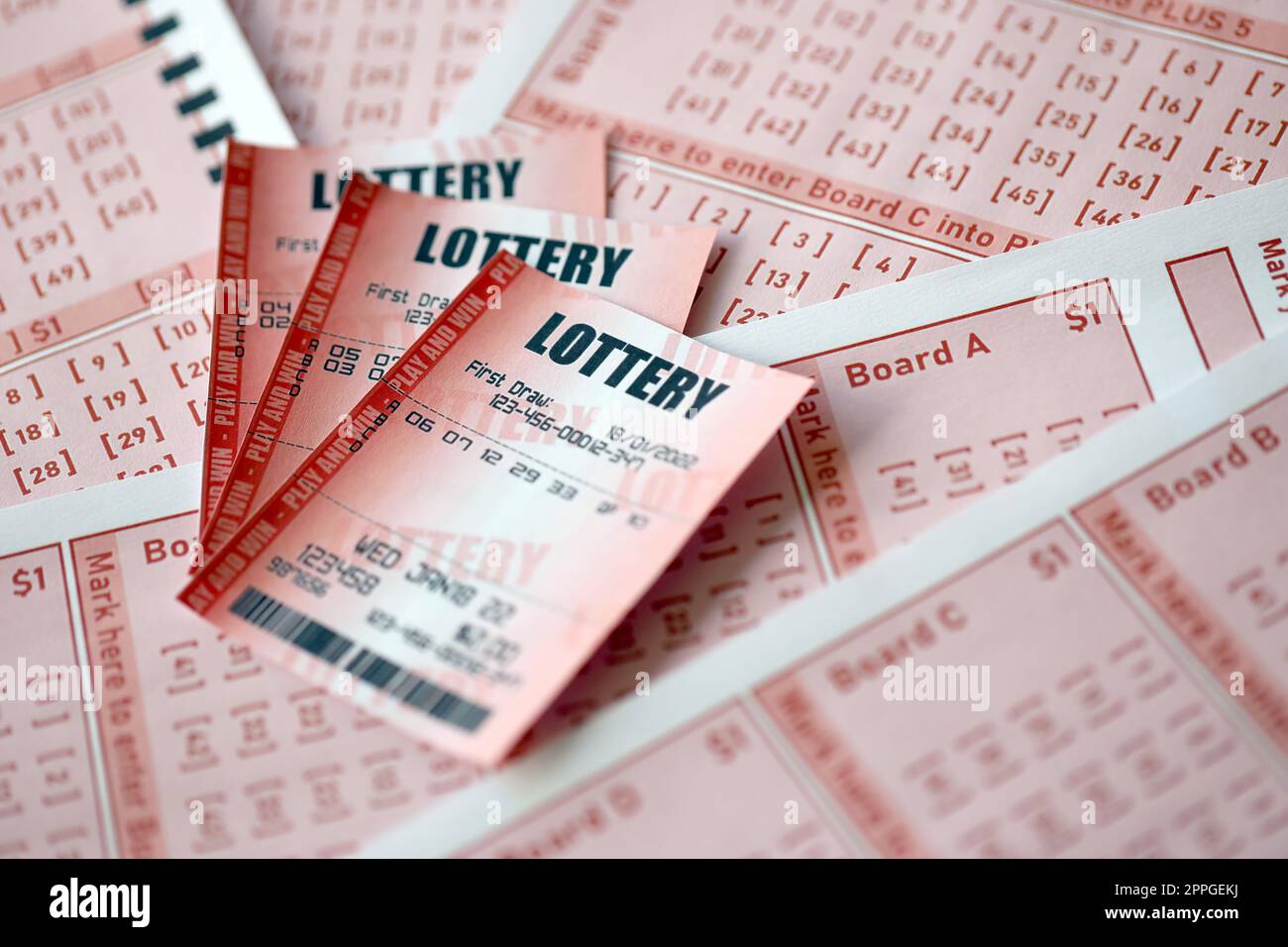 Red lottery ticket lies on pink gambling sheets with numbers for ...