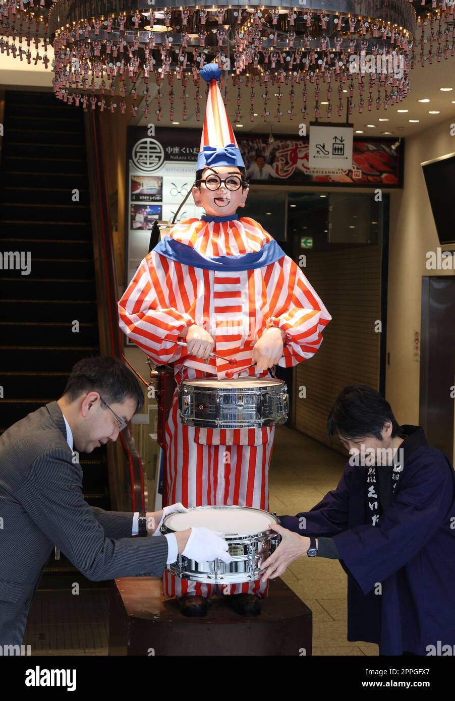 Kuidaore Taro, a mechanical drum-playing clown receives a drum made by ...