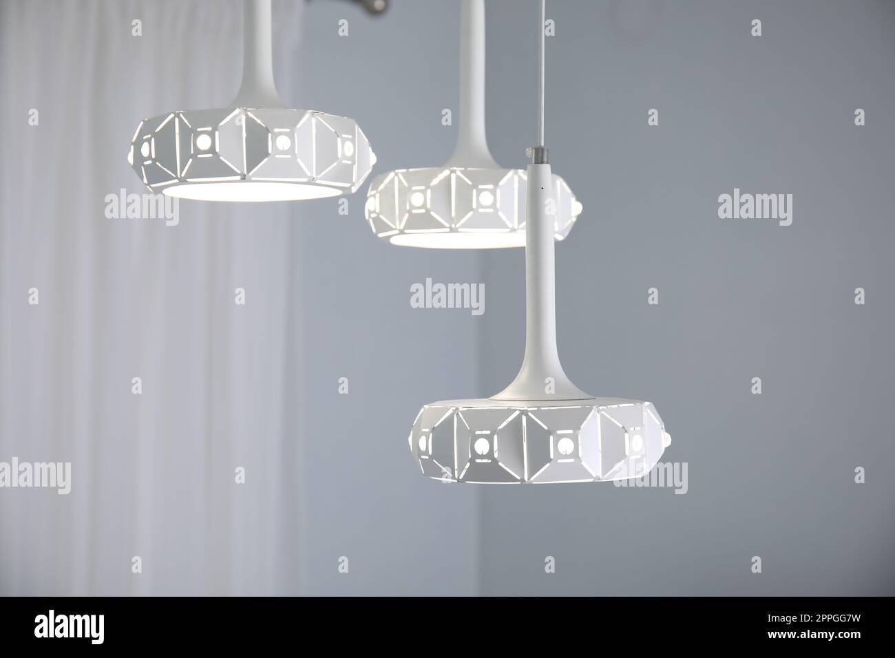 Stylish white pendant lamp in light room Stock Photo - Alamy