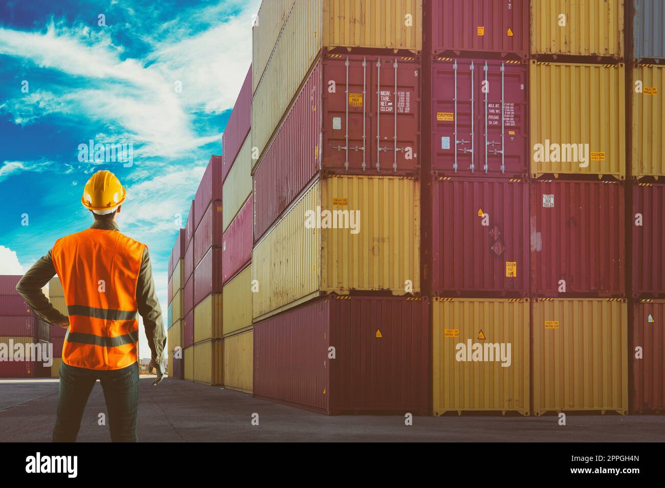 Man at work among containers in a commercial port Stock Photo - Alamy
