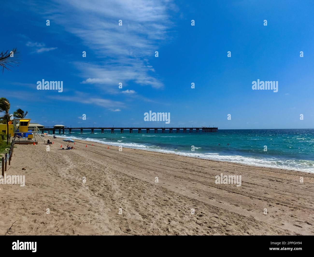 Long distance view of the sunny and tropical blue water shoreline with ...