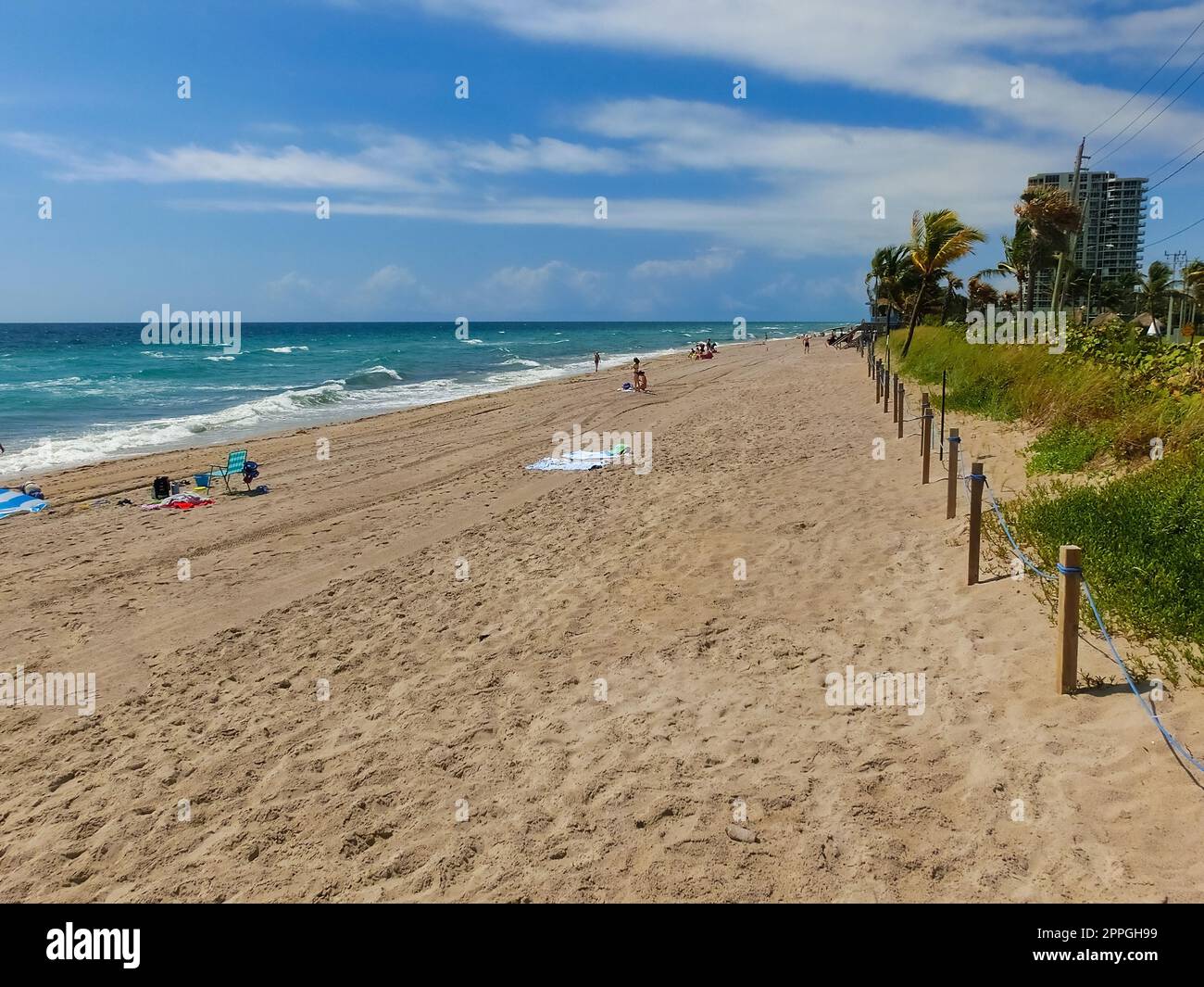 Long distance view of the sunny and tropical blue water shoreline with ...