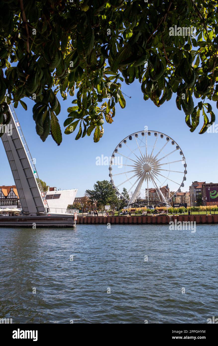 The Draw Footbridge over the MotÅ‚awa River and Ferris wheel on the ...