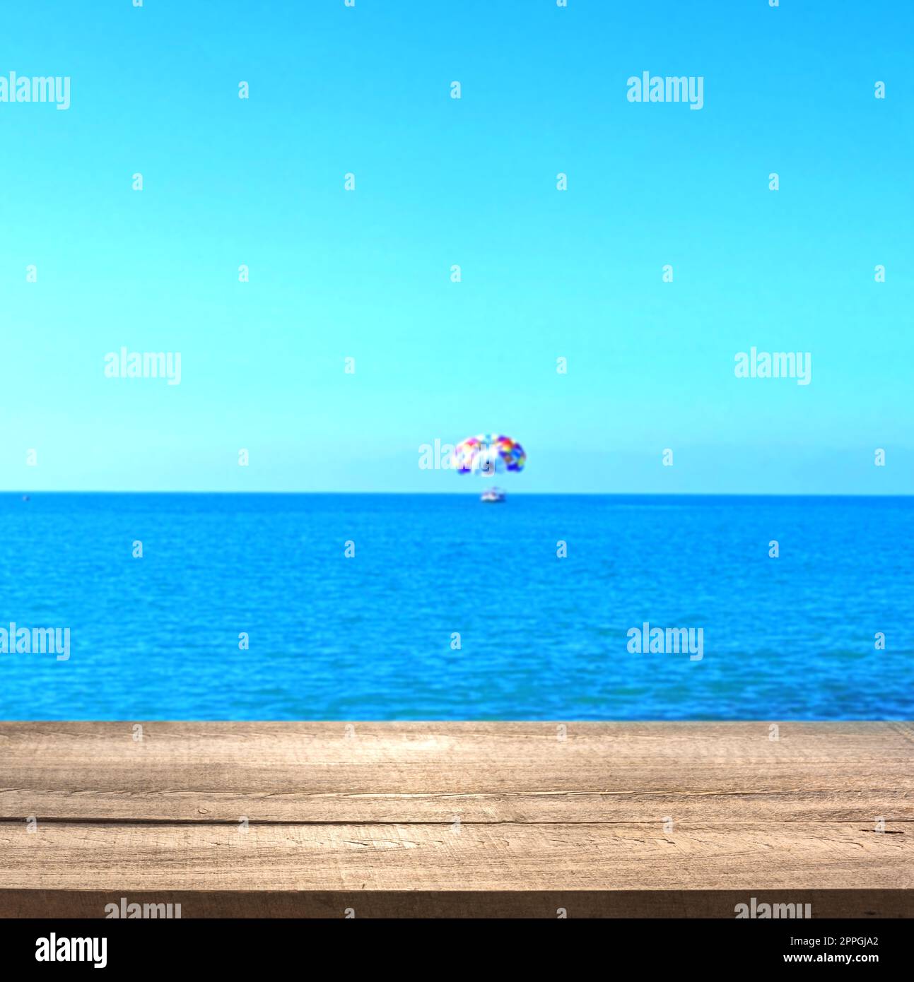 Wooden desk of free space and tropic blue sea landscape with boat ...