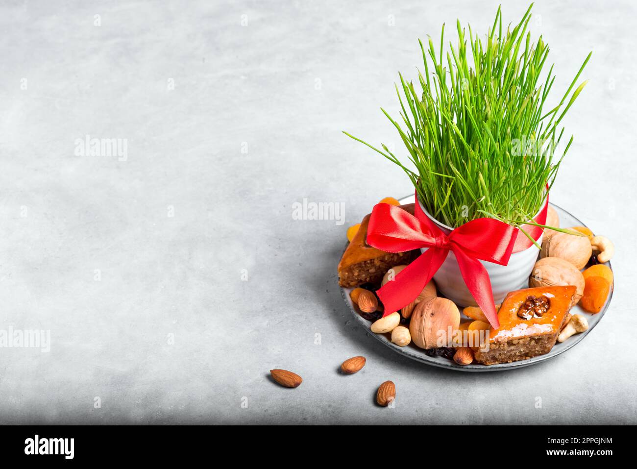 Novruz setting table decoration, wheat grass, baklava pastry and nuts ...