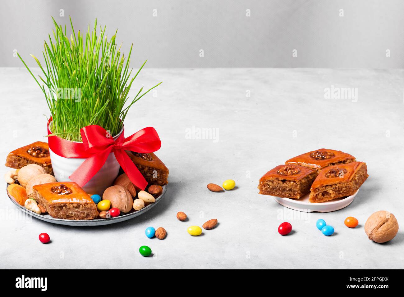 Novruz setting table decoration, wheat grass, baklava pastry and nuts ...