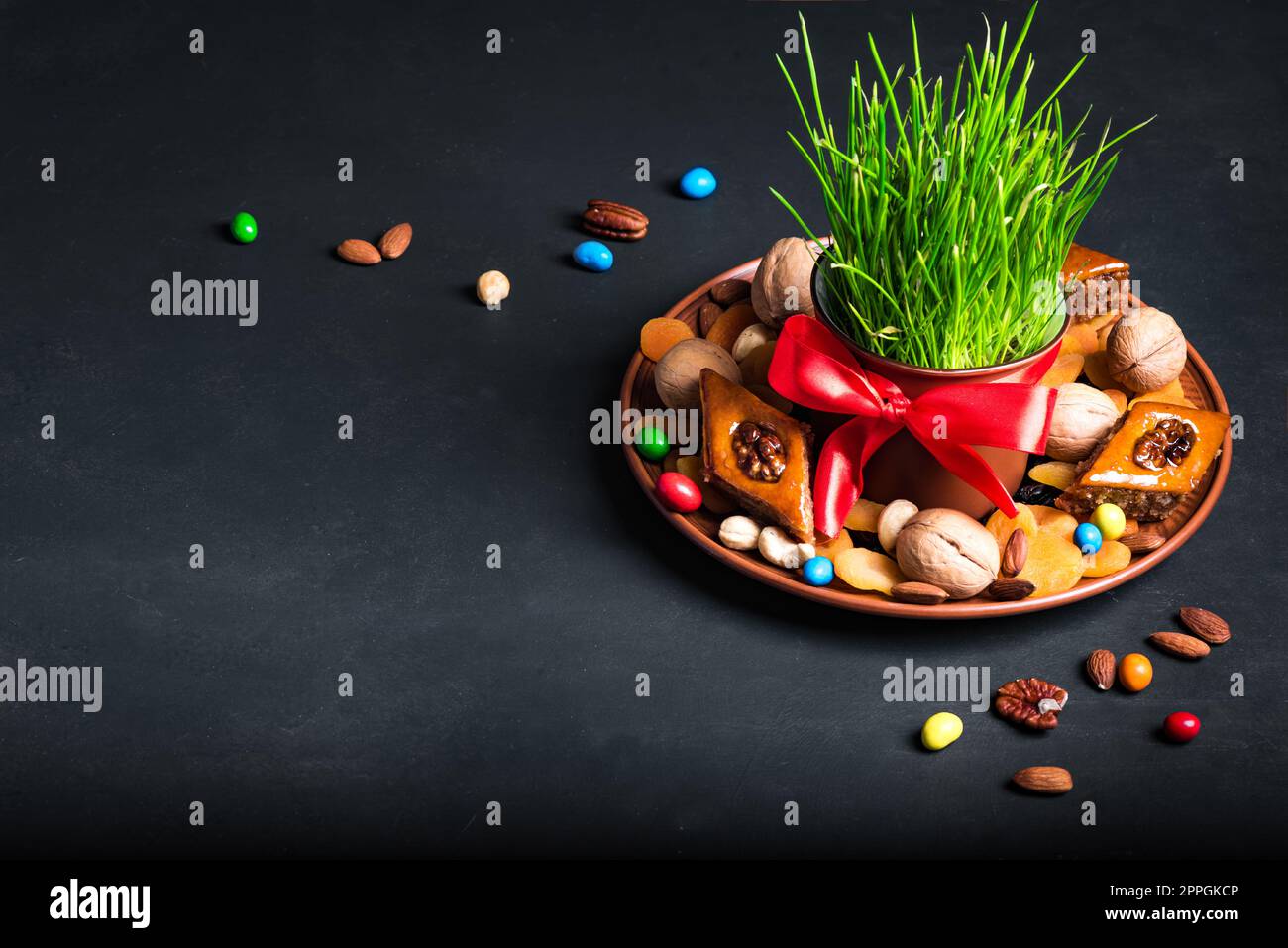 Novruz setting table decoration, wheat grass, baklava pastry and nuts ...