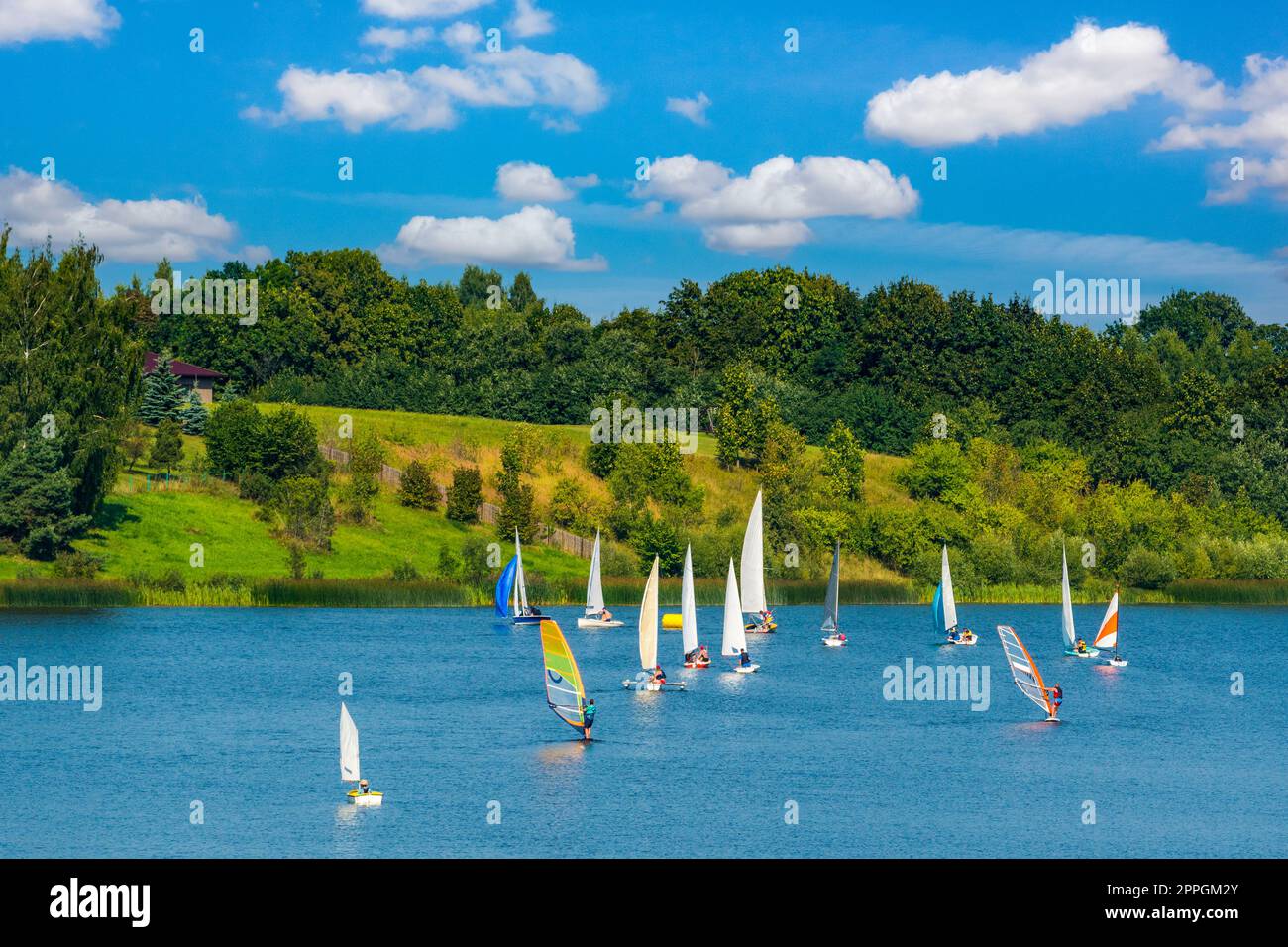 Group of sailboats sailing along the lake water Stock Photo - Alamy
