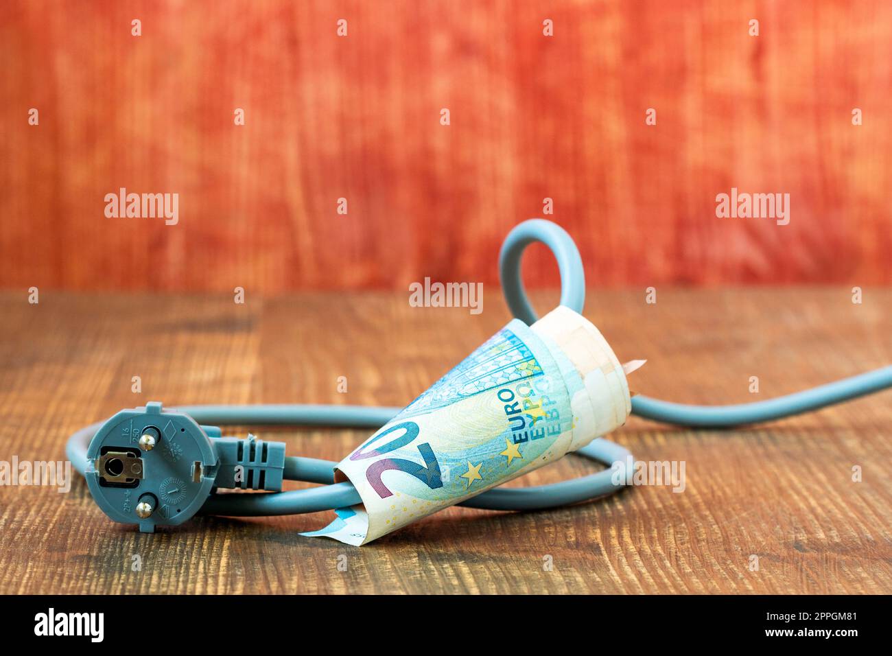 Electric plug and rolled up euro banknotes Stock Photo - Alamy