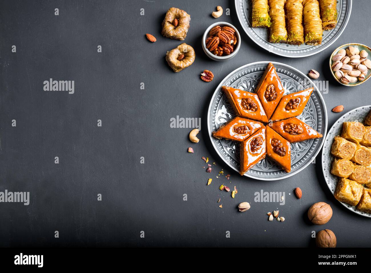 Arabic Baklava with nuts and honey on black, copy space, top view ...
