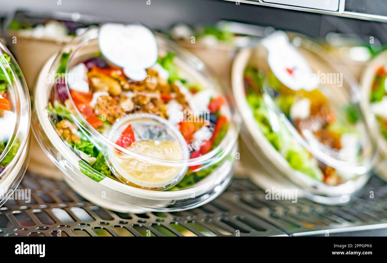 Pre-packaged ready to eat meals displayed in a commercial refrigerator ...