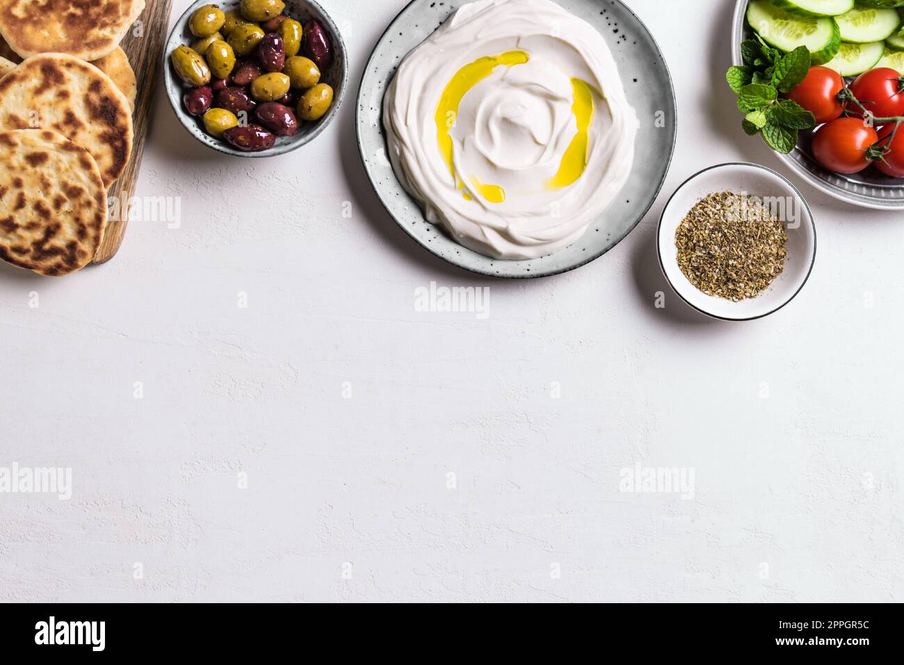 Labneh yogurt cream cheese with olive oil, zaatar, olives, vegetables ...