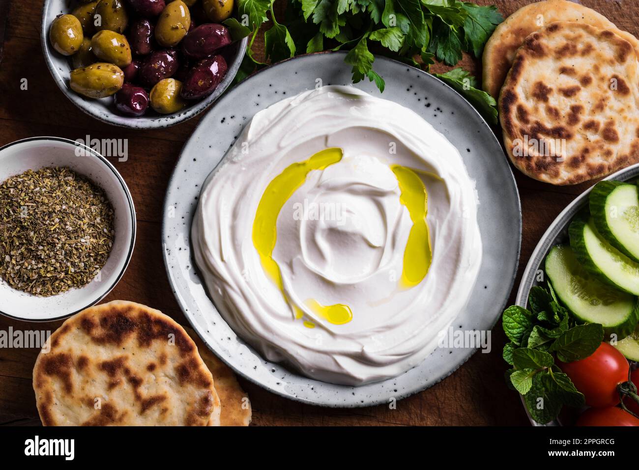 Labneh yogurt cream cheese with olive oil, zaatar, olives, vegetables ...