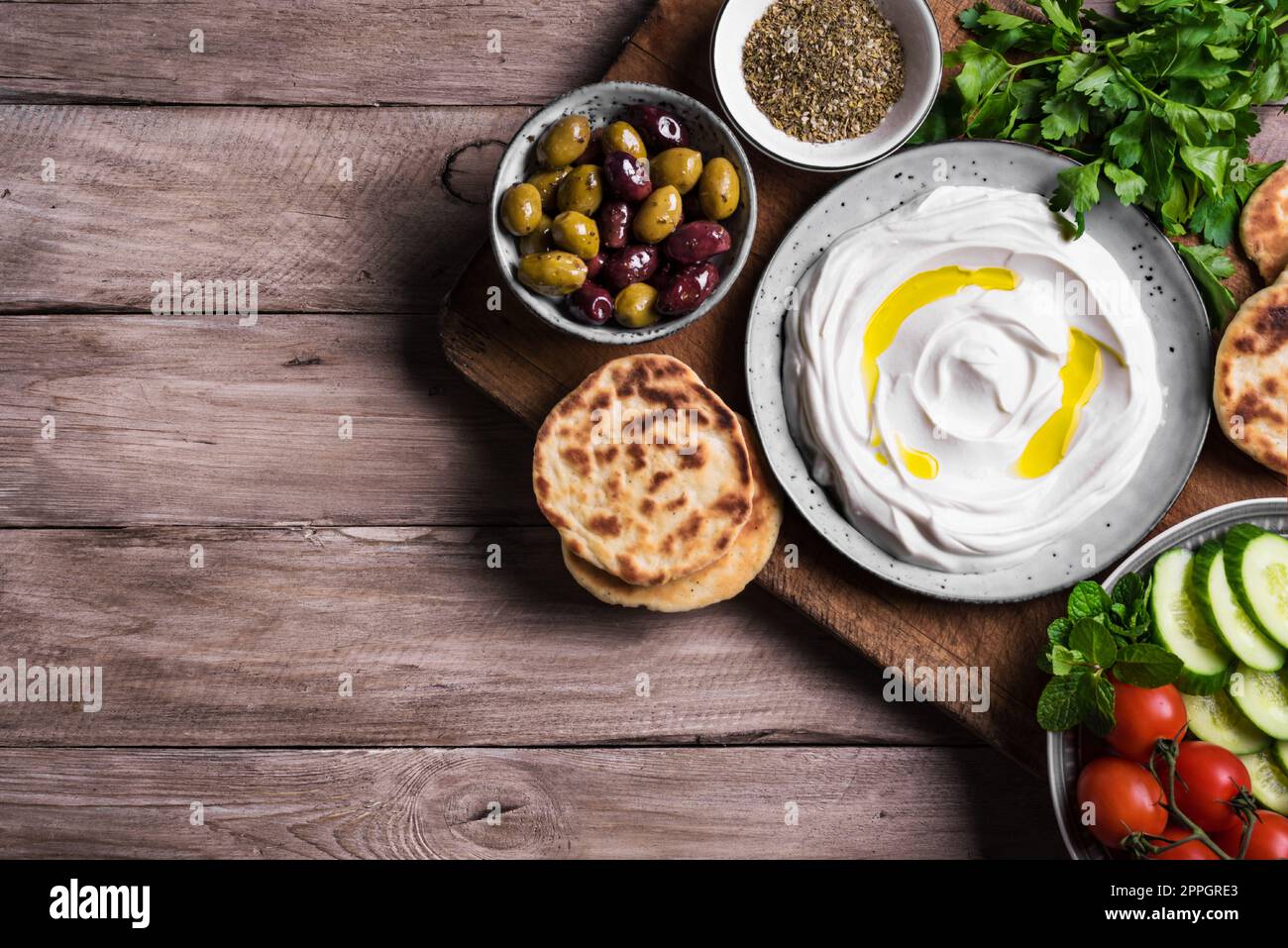 Labneh yogurt cream cheese with olive oil, zaatar, olives, vegetables ...