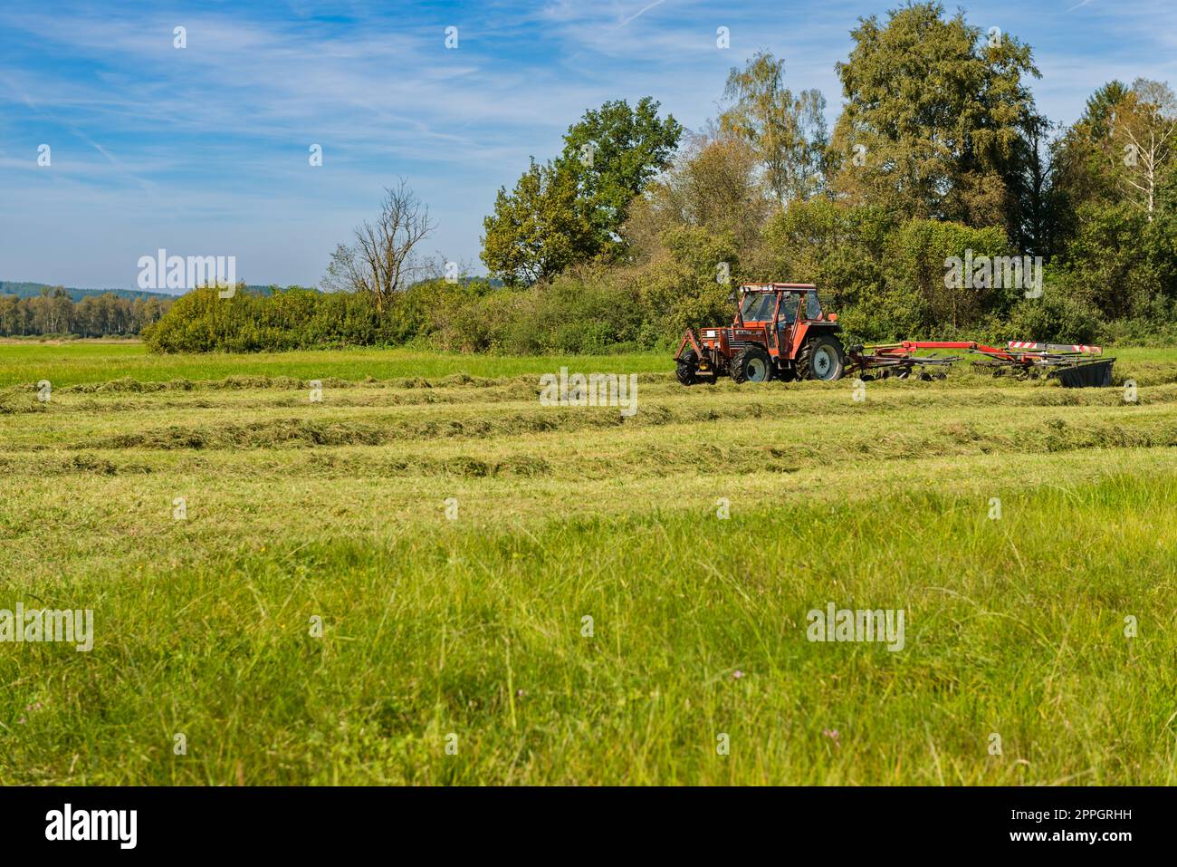 Mowing meadows: With tractor and mower unit Stock Photo - Alamy