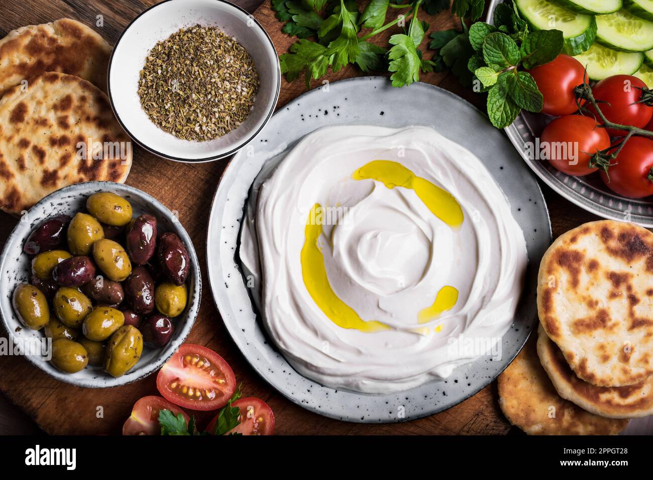 Labneh yogurt cream cheese with olive oil, zaatar, olives, vegetables ...