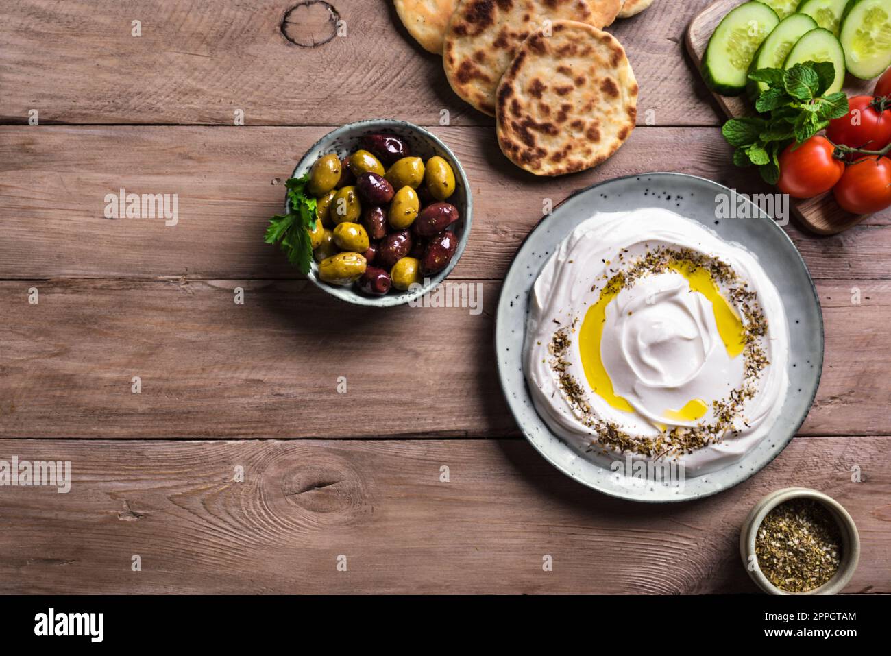 Labneh yogurt cream cheese with olive oil, zaatar, olives, vegetables ...