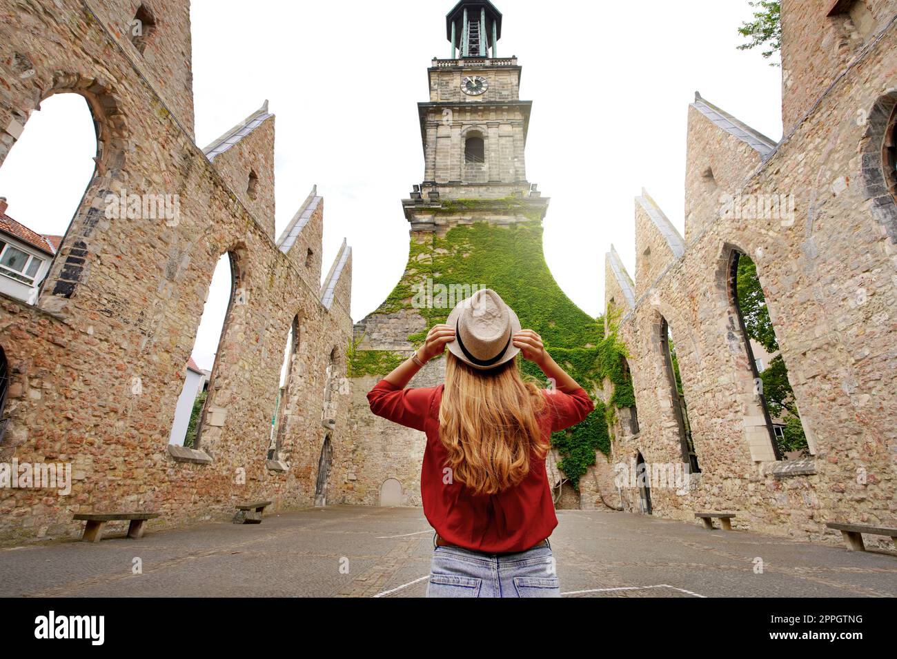 Tourism in Germany. Tourist girl visiting the ruins of the church of ...