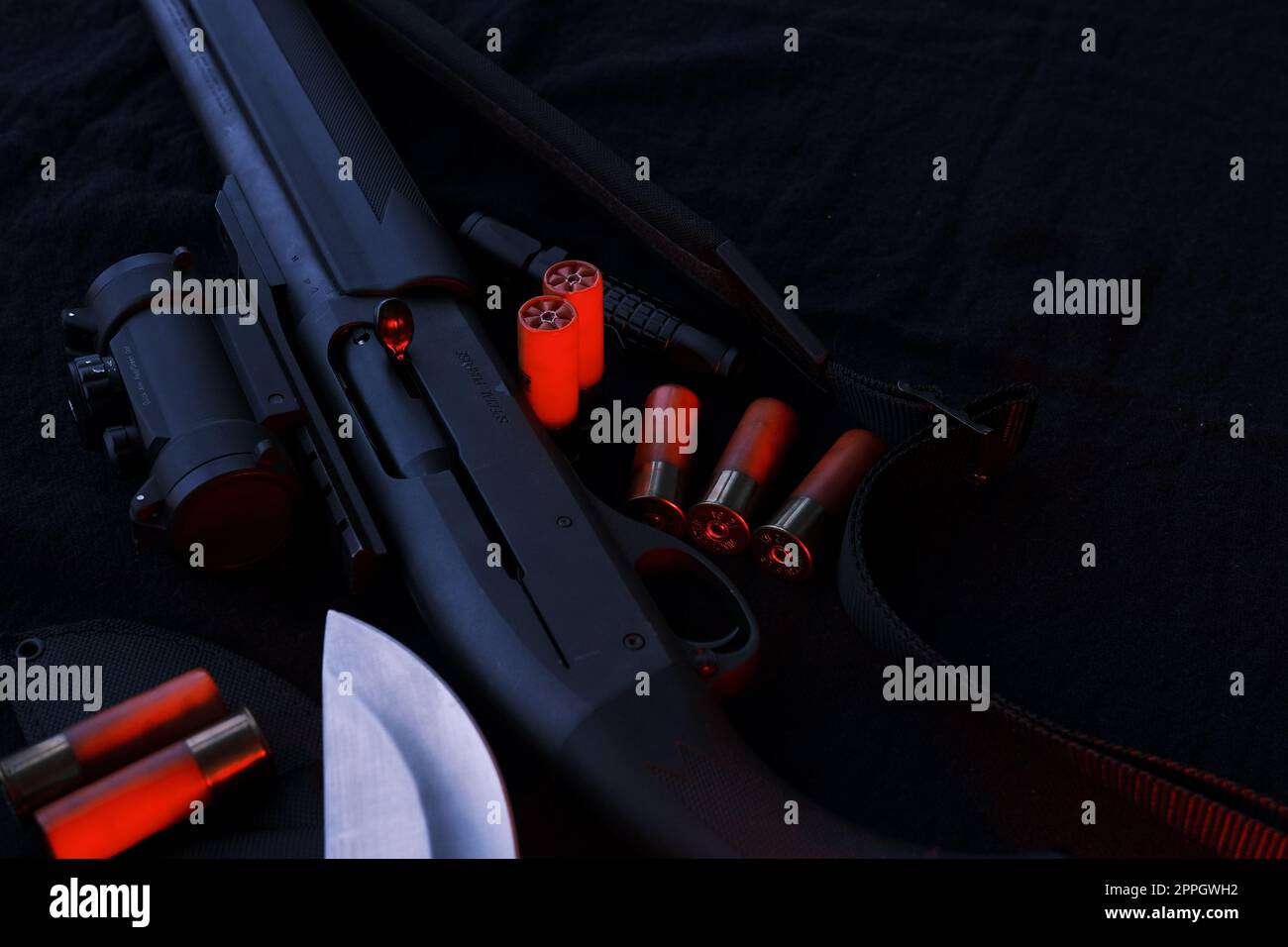 Weapon on black cloth: knife, rifle, shells,top view. Top view of knife ...