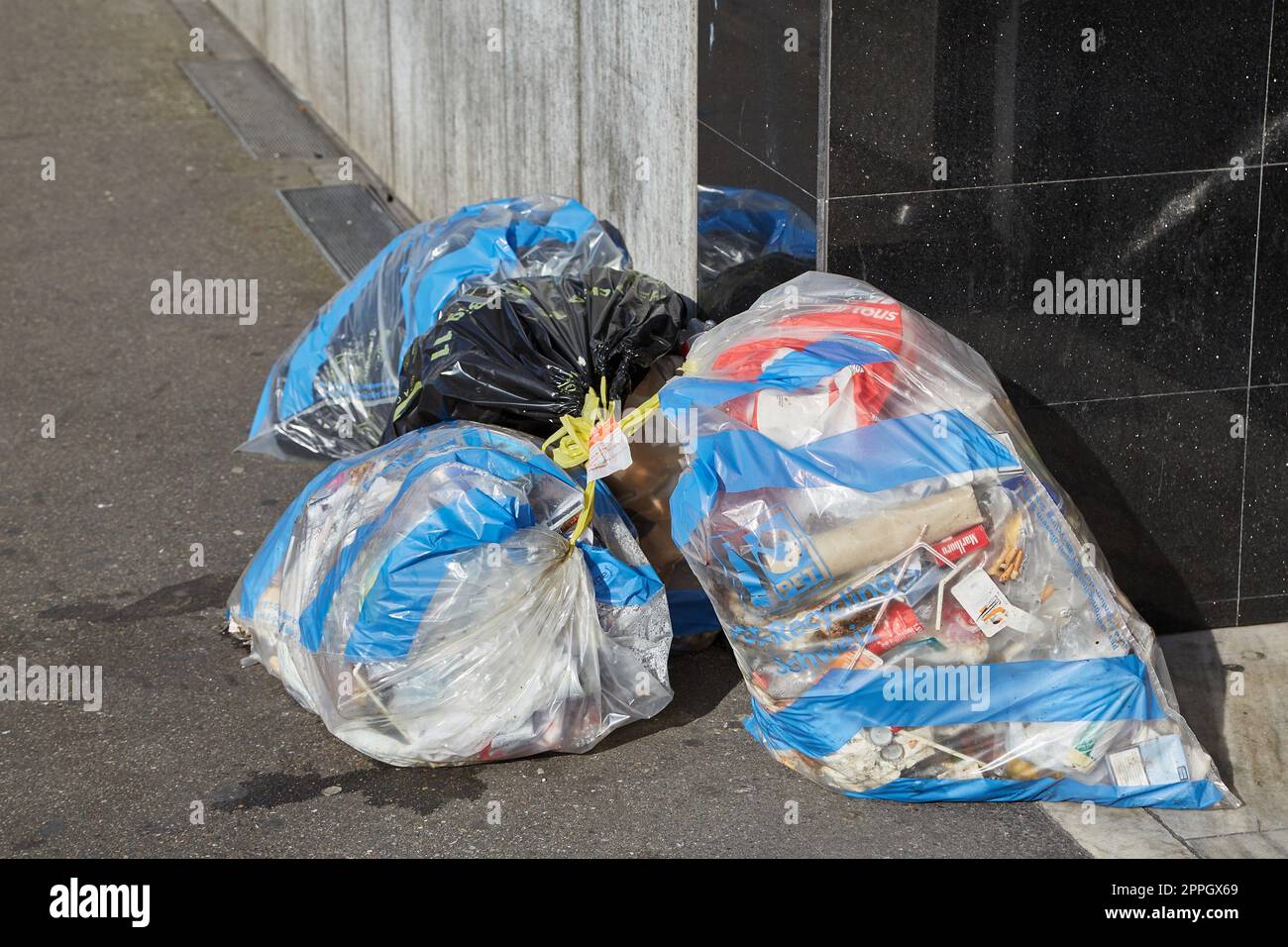 Garbage bag on a city street Stock Photo - Alamy