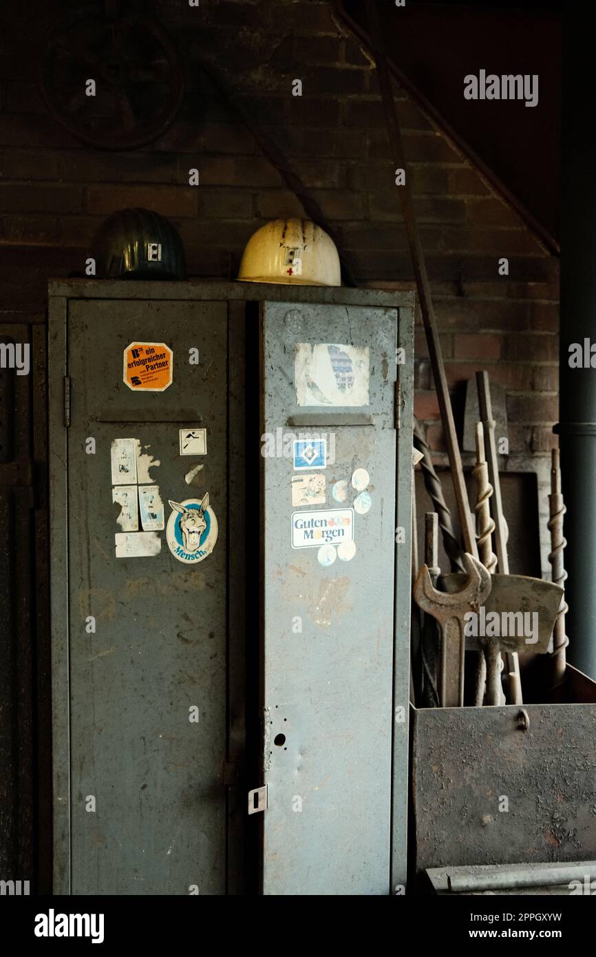 Vertical shot of the miner's helmets on an old locker in a mine in the ...