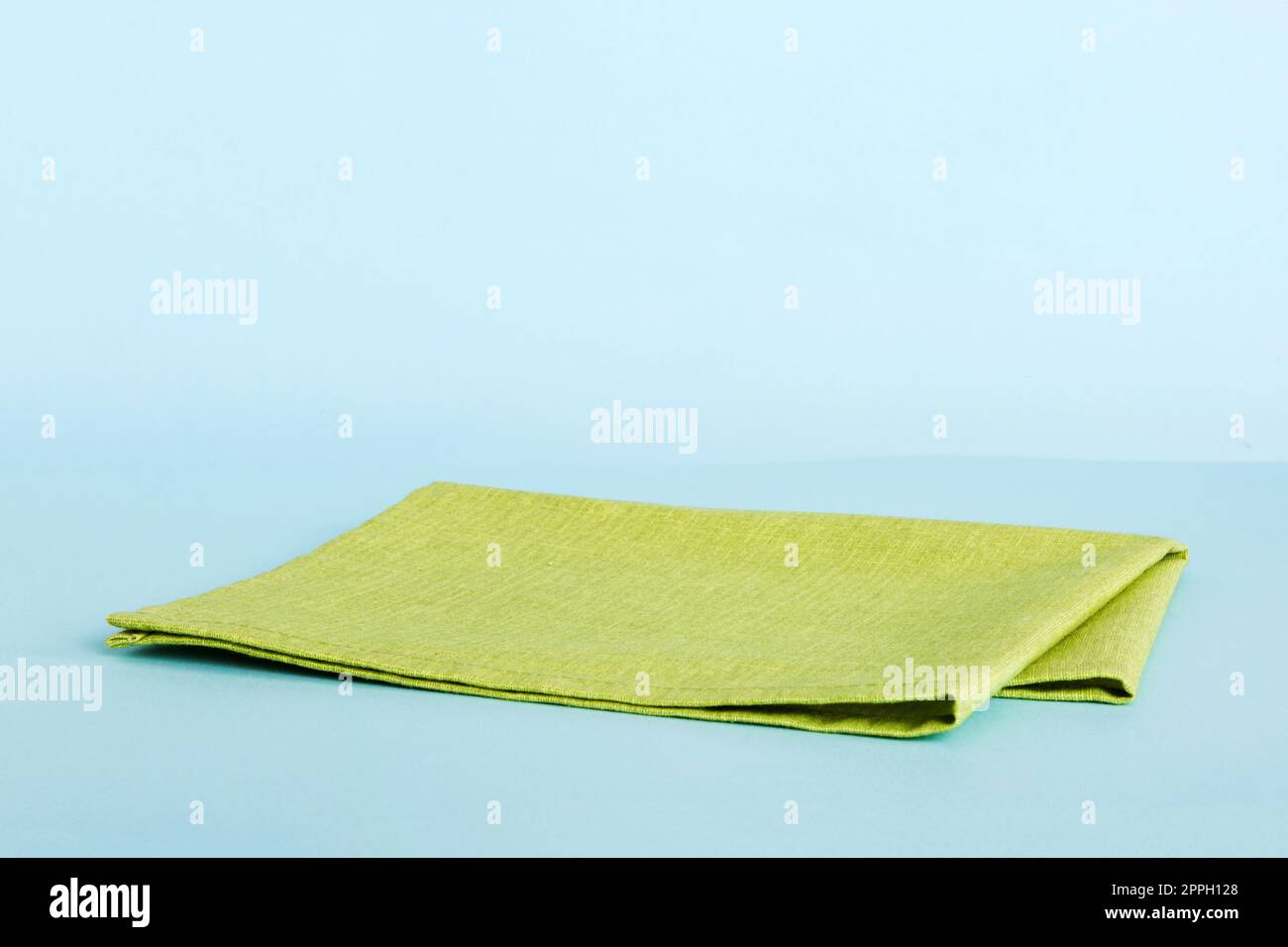 top view with green kitchen napkin isolated on table background. Folded ...