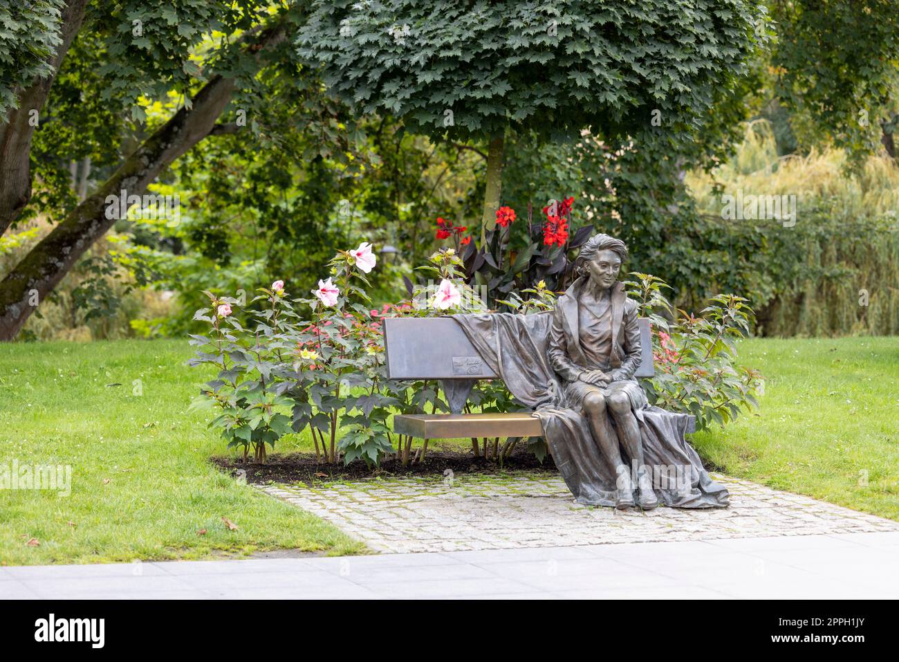 Monument of Polish singer Irena Jarocka sitting on a bench in a park ...